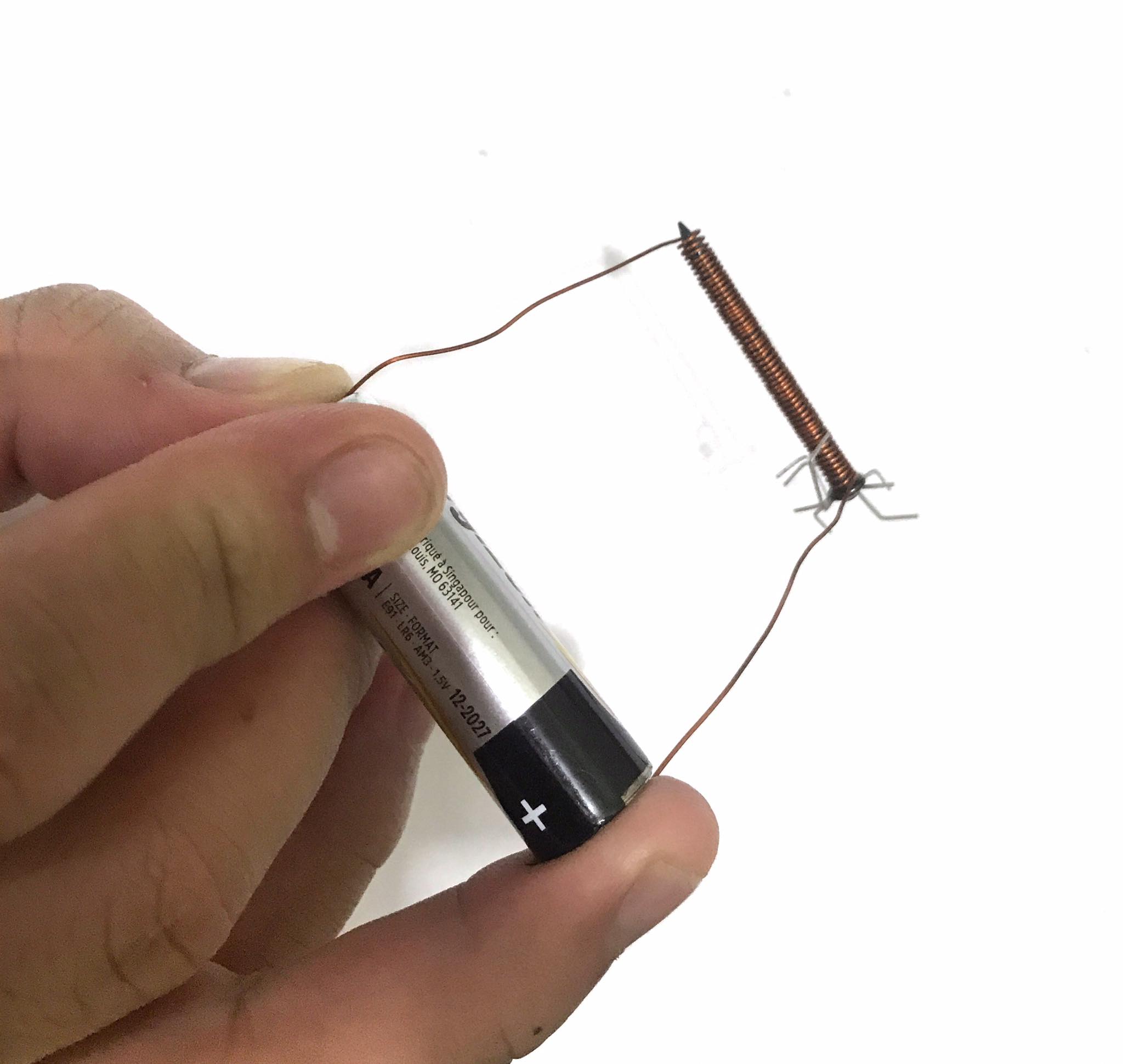 Test the strength of your electromagnet with a staple wire. You’ll see ...