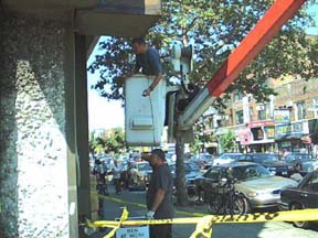 A sign being hung-up on 13th Avenue
